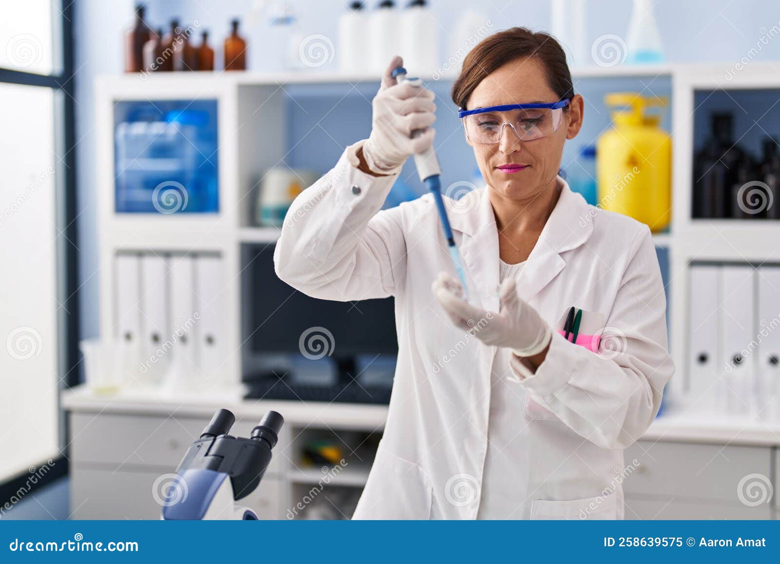 Middle Age Woman Wearing Scientist Uniform Using Pipette at Laboratory ...
