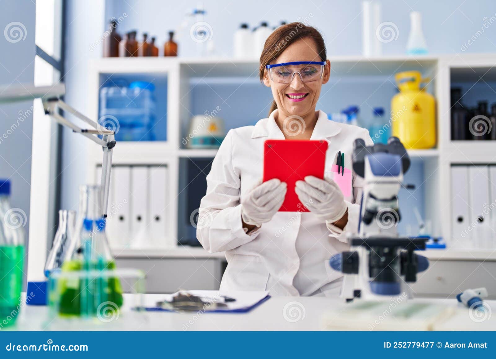 Middle Age Woman Wearing Scientist Uniform Using Touchpad at Laboratory ...