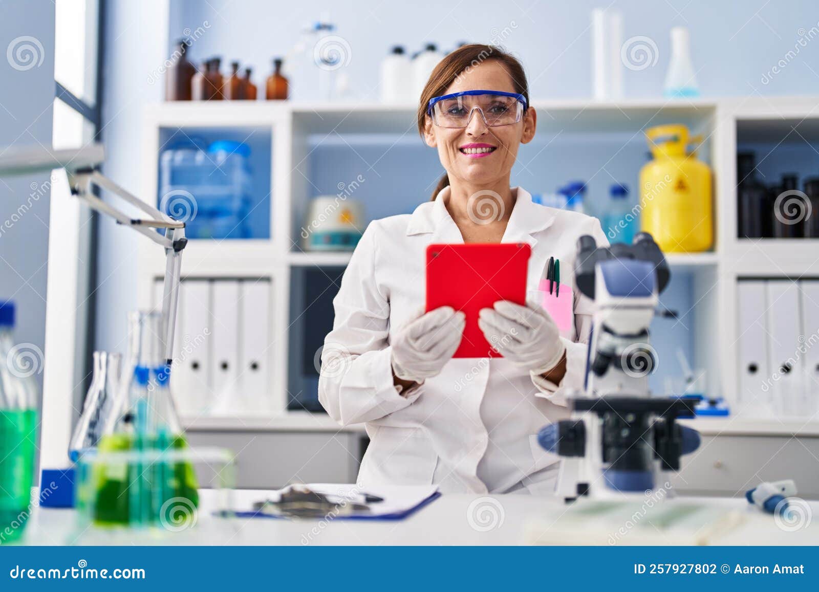 Middle Age Woman Wearing Scientist Uniform Using Touchpad at Laboratory ...