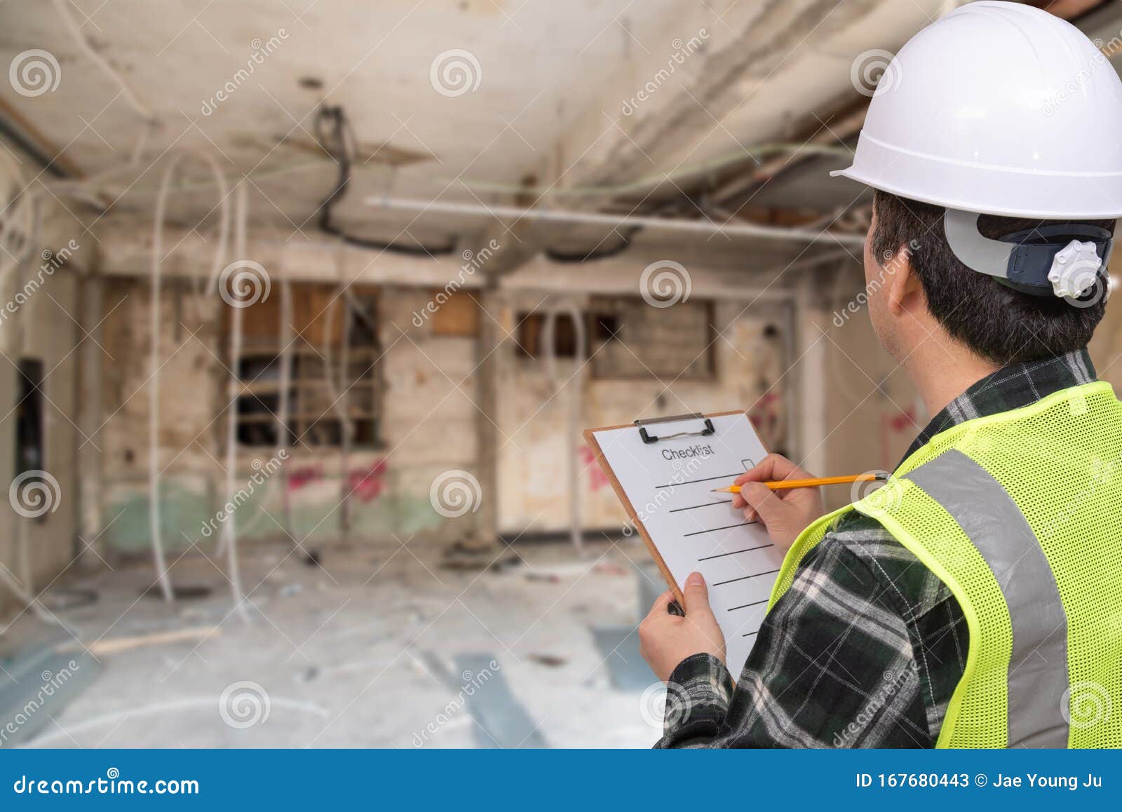 A Middle-aged Asian Worker Checking Something with a Checklist in His ...