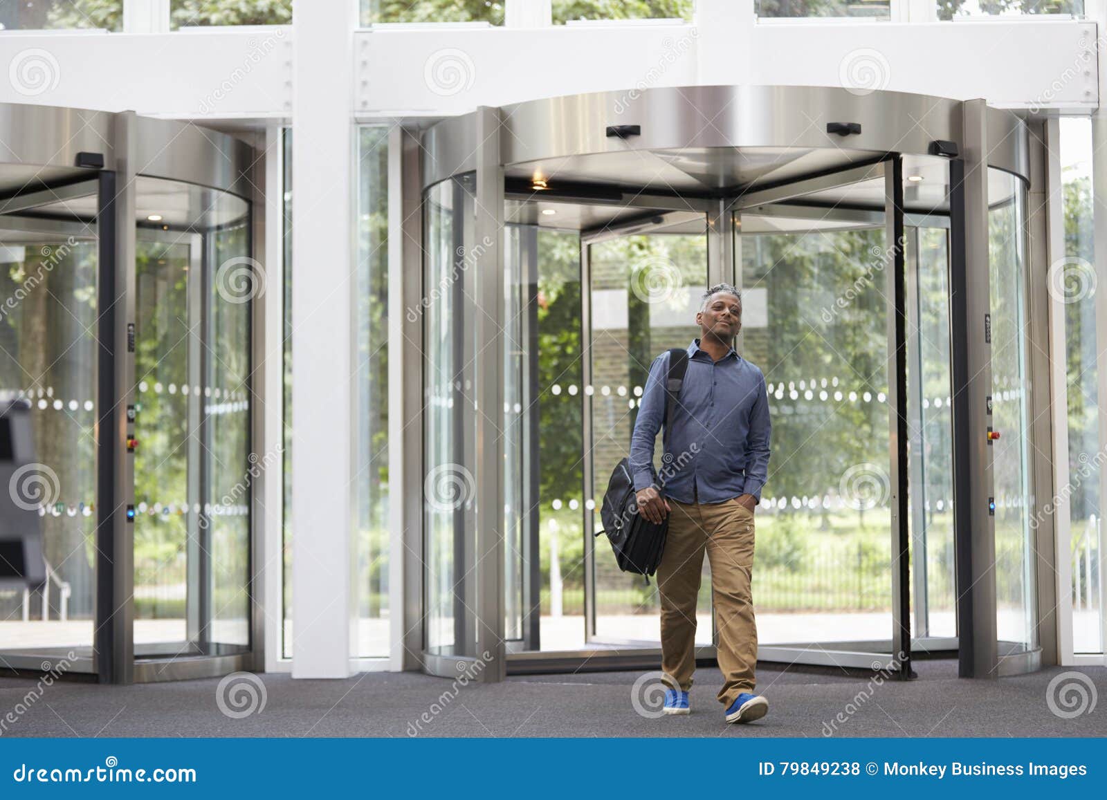Middle Aged Black Man Entering the Foyer of Modern Building Stock Photo ...