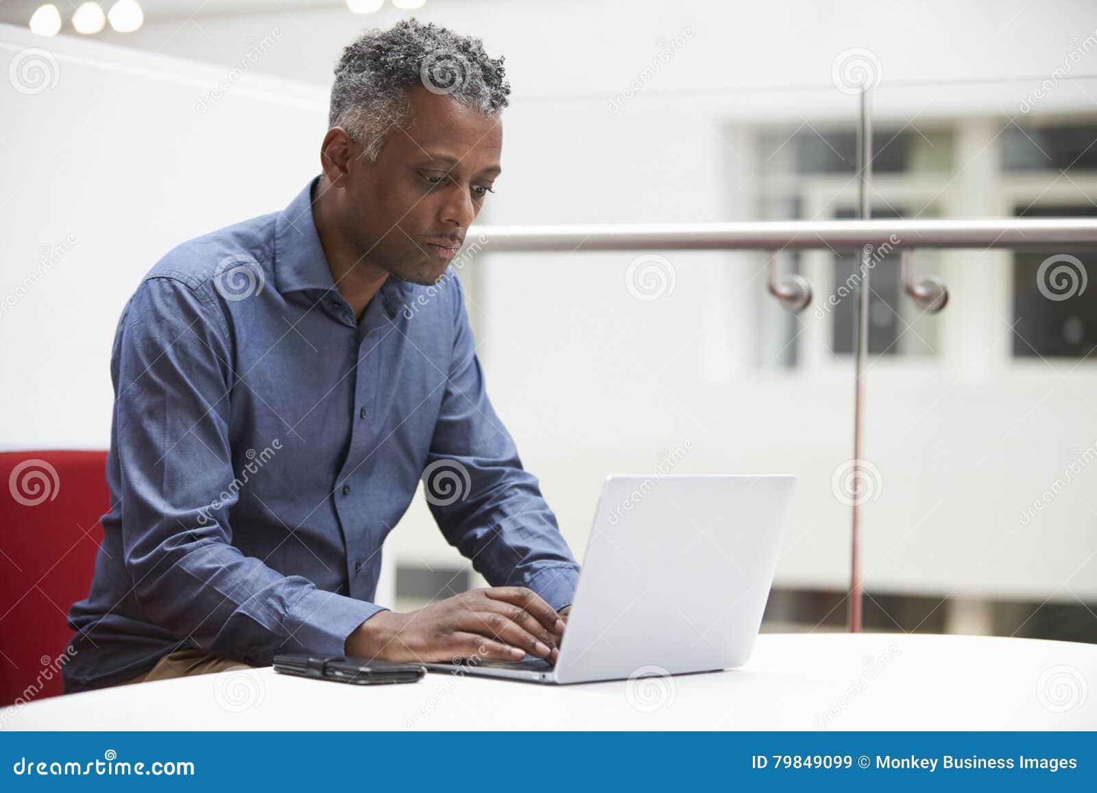 Middle Aged Black Man Using Laptop in a Modern Interior Stock Image ...