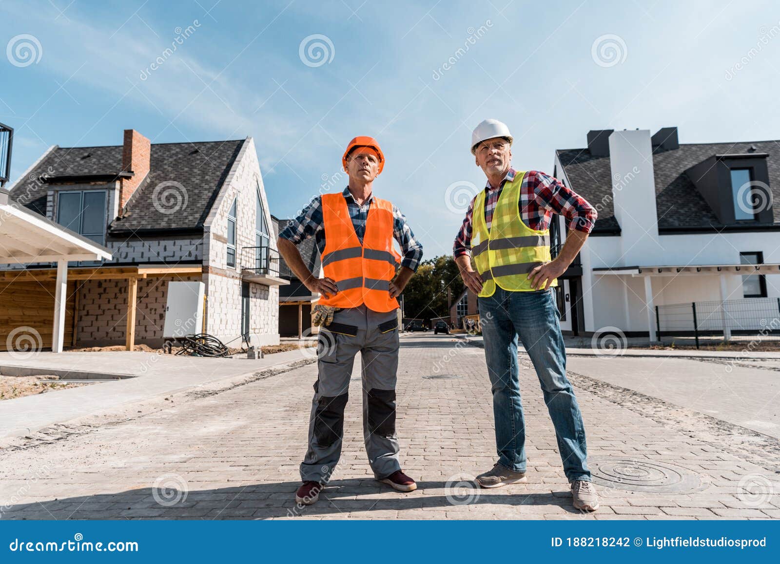 Builders Standing with Hands on Hips Outside Stock Photo - Image of ...