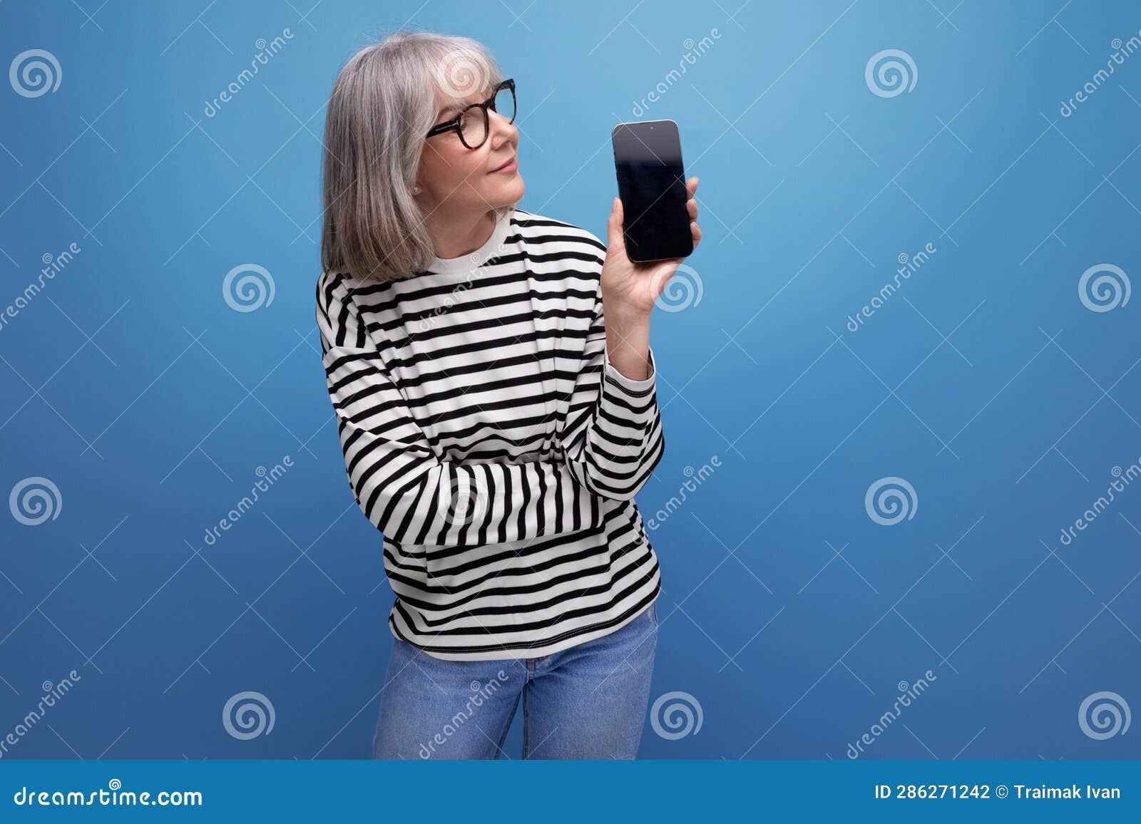 Middle Aged Business Woman Surfs the Internet Using Smartphone on ...