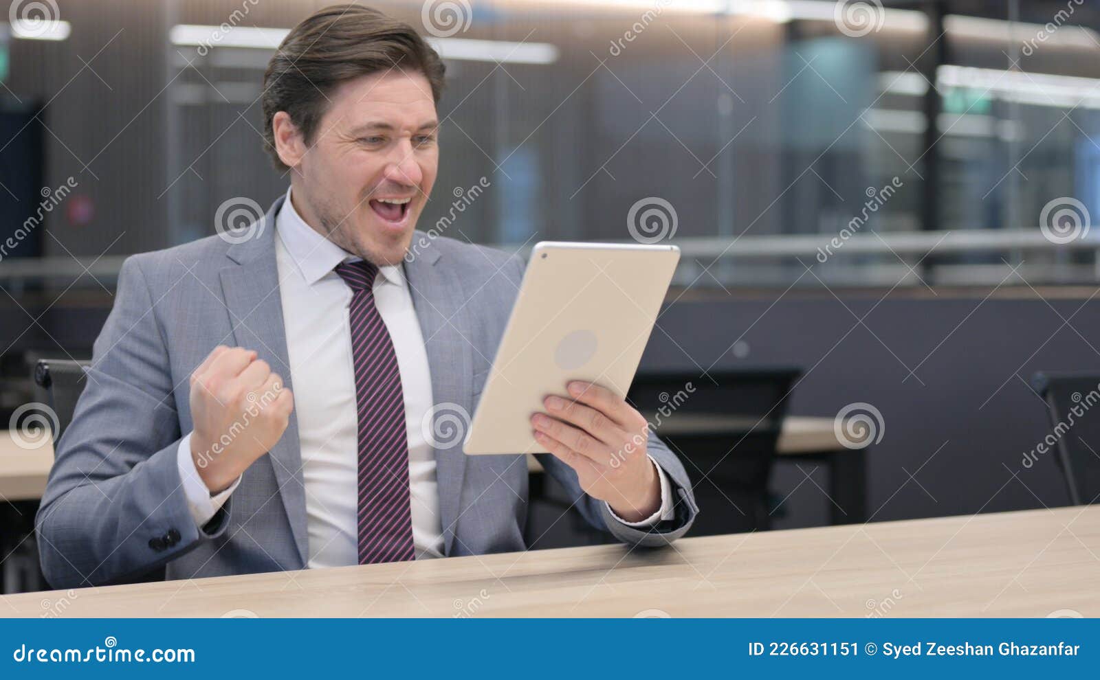 Middle Aged Businessman Celebrating Success on Tablet Stock Image ...
