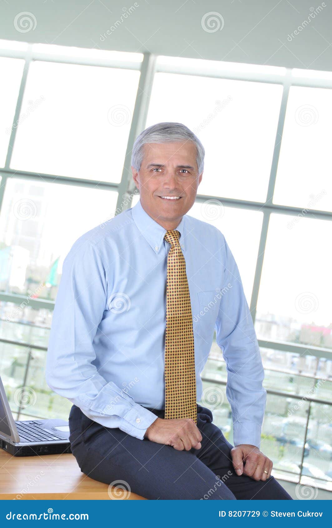 Middle Aged Businessman Seated on His Desk Stock Image - Image of ...