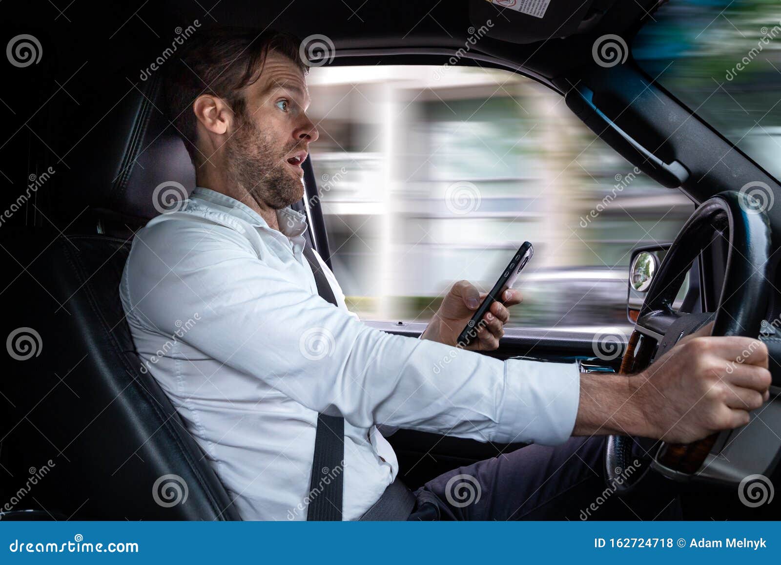 A Middle Aged Caucasian Man Distracted Driving while Using a Mobile ...