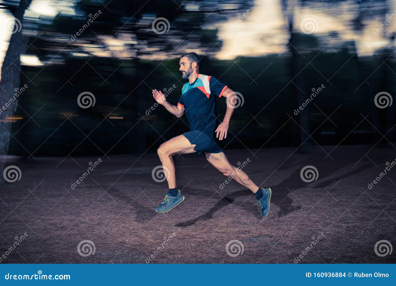 Middle Aged Caucasian Man Trail Runner Training Fast Speed in the ...