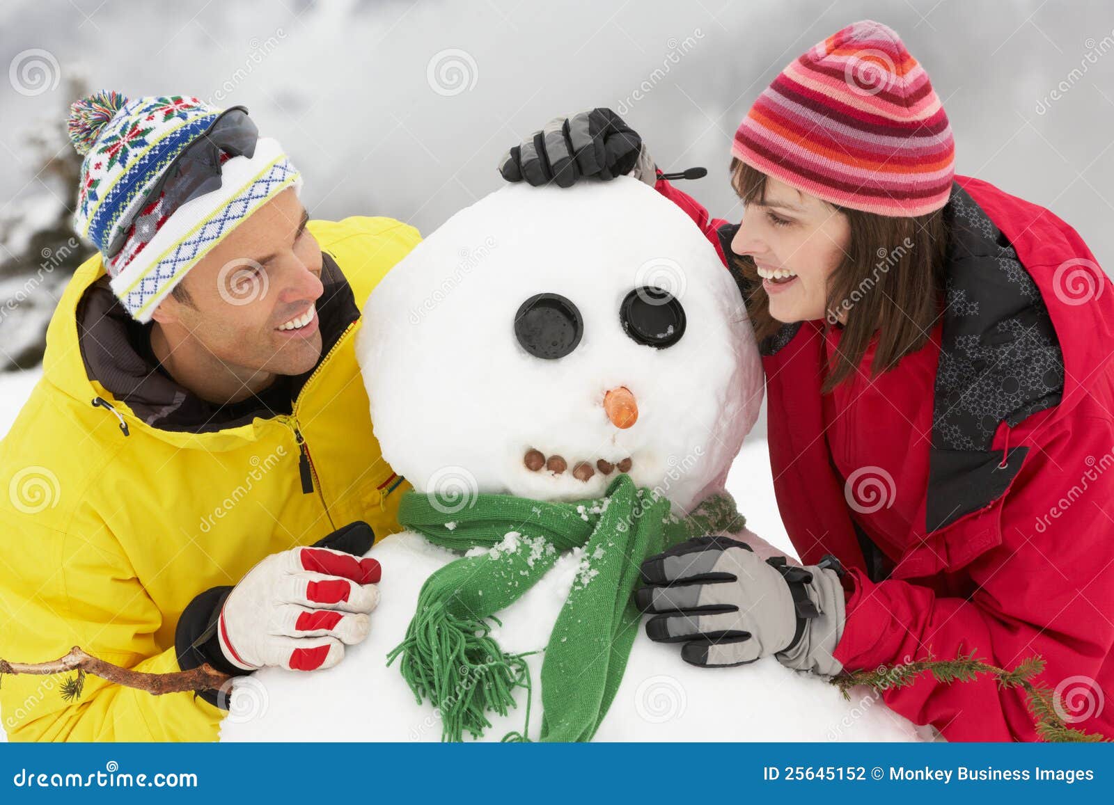 Middle Aged Couple Building Snowman on Ski Holiday Stock Photo - Image ...