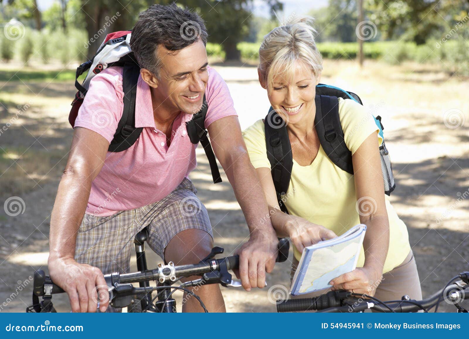 Middle Aged Couple Cycling through Countryside Stock Image - Image of ...