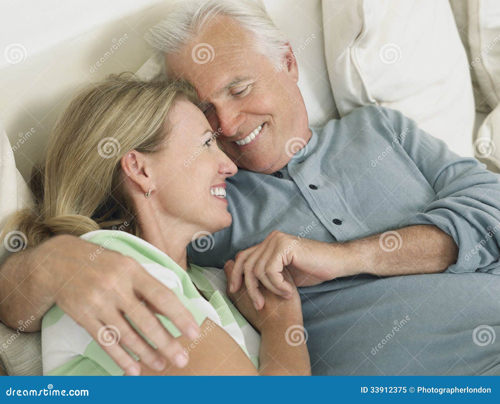 Middle Aged Couple Embracing in Bed Stock Image - Image of leisure ...