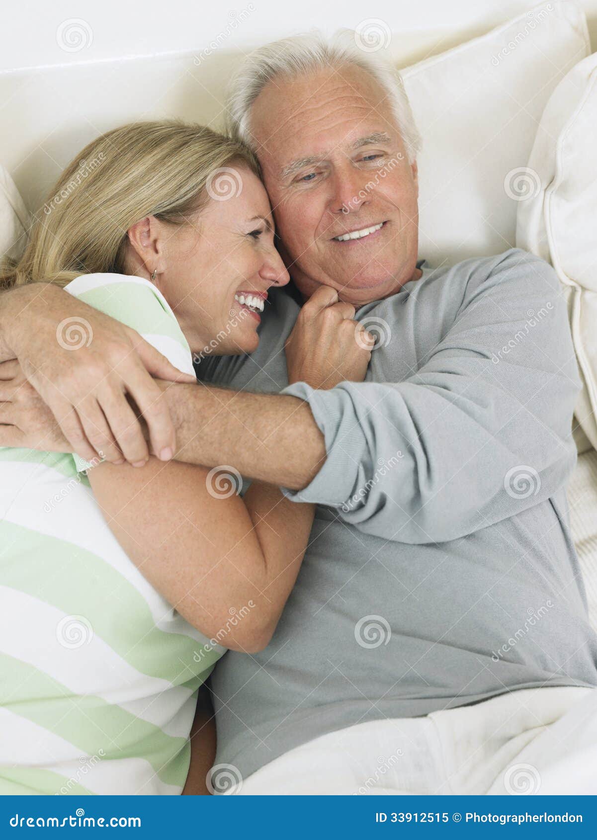 Middle Aged Couple Embracing in Bed Stock Image - Image of hugging ...