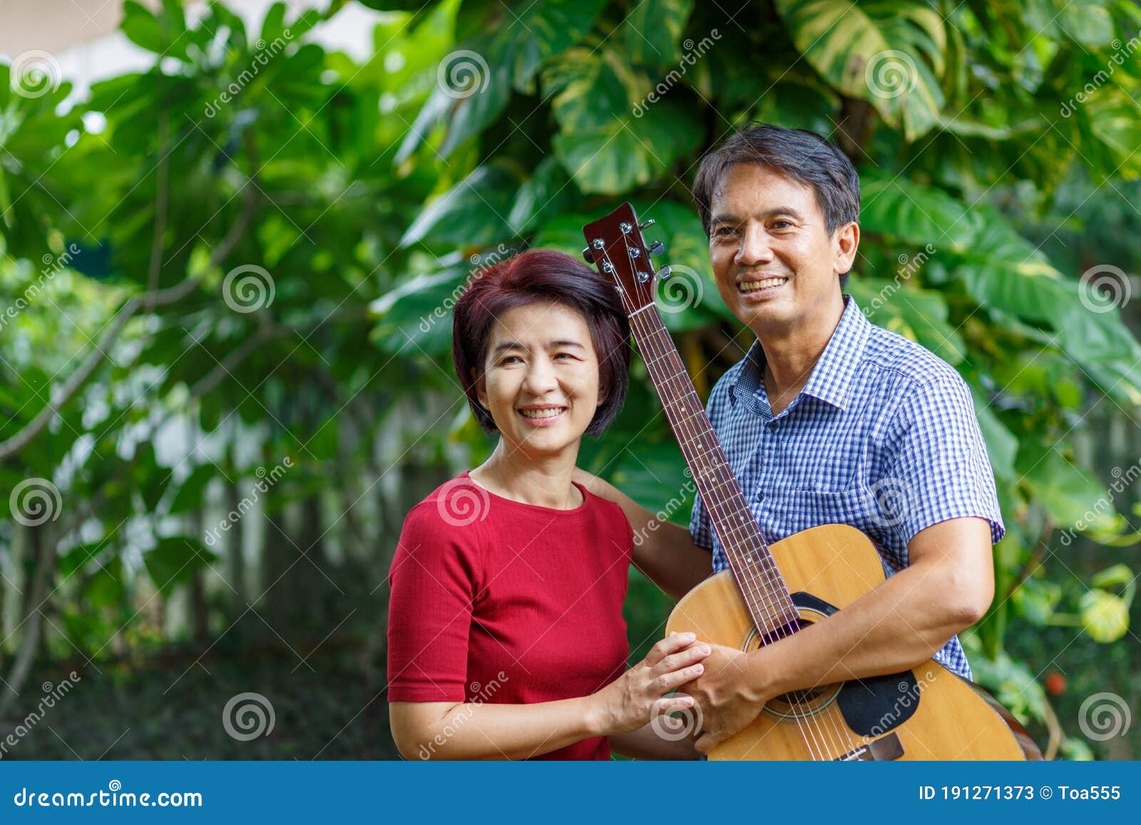 Middle Aged Couple Playing Guitar while Relax in Backyard Stock Image ...