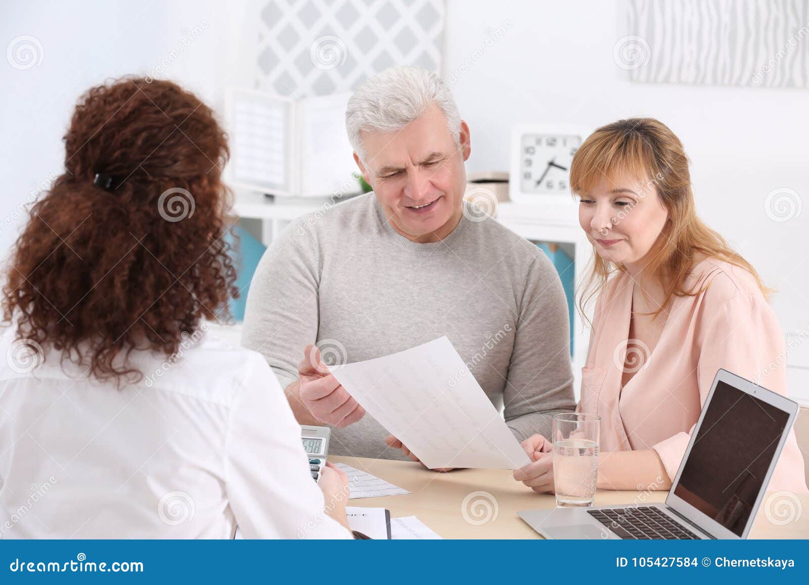 Middle Aged Couple Signing Contract at Insurance Agency Stock Photo ... Middle Aged Couple Signing Contract at Insurance Agency Stock Photo ...