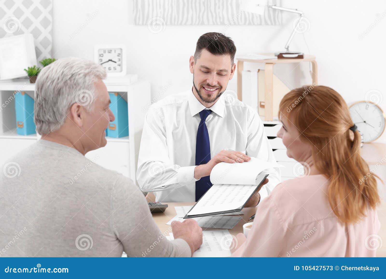 Middle Aged Couple Signing Contract at Insurance Agency Stock Image ... Middle Aged Couple Signing Contract at Insurance Agency Stock Image ...