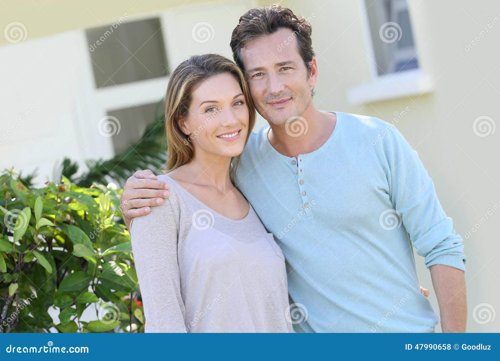 Middle-aged Couple Standing in Front of House Stock Photo - Image of ...