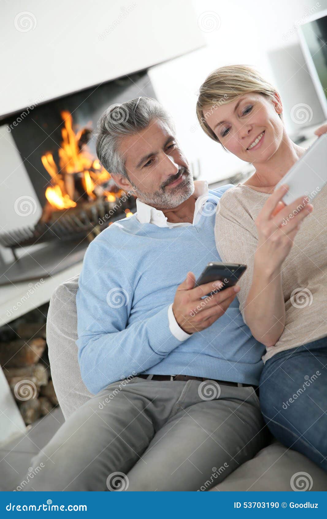 Middle-aged Couple Using Their Smartphones at Home Stock Photo - Image ...