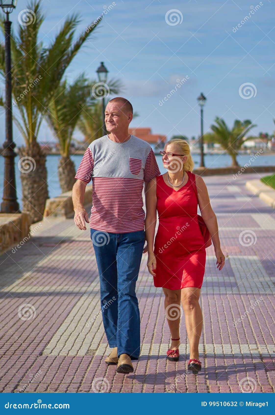 Couple Strolling on Promenade Stock Photo - Image of middle, happy ...