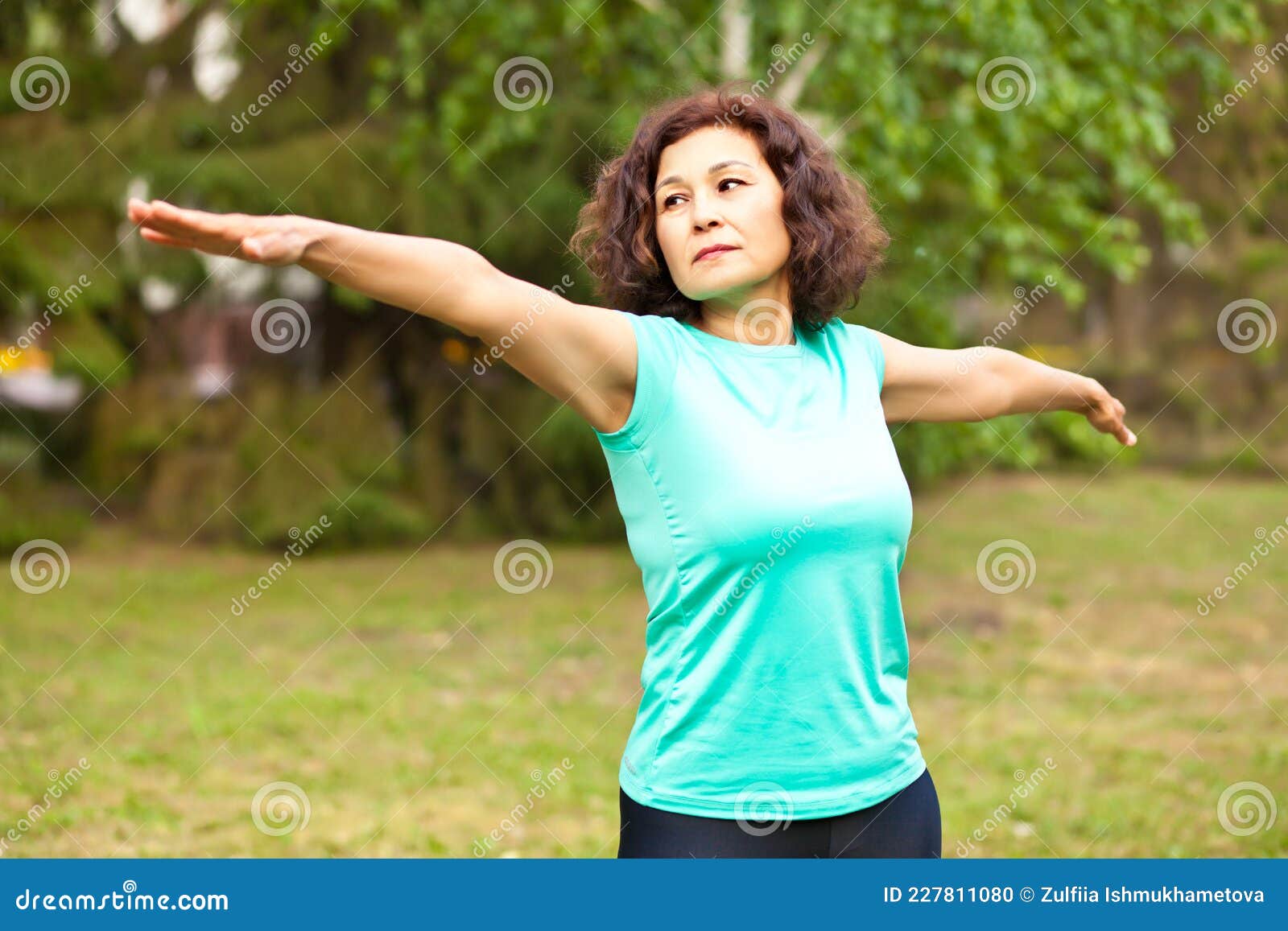 Middle Aged Elderly Active Woman Doing Exercise in a Park Outdoor Stock ...
