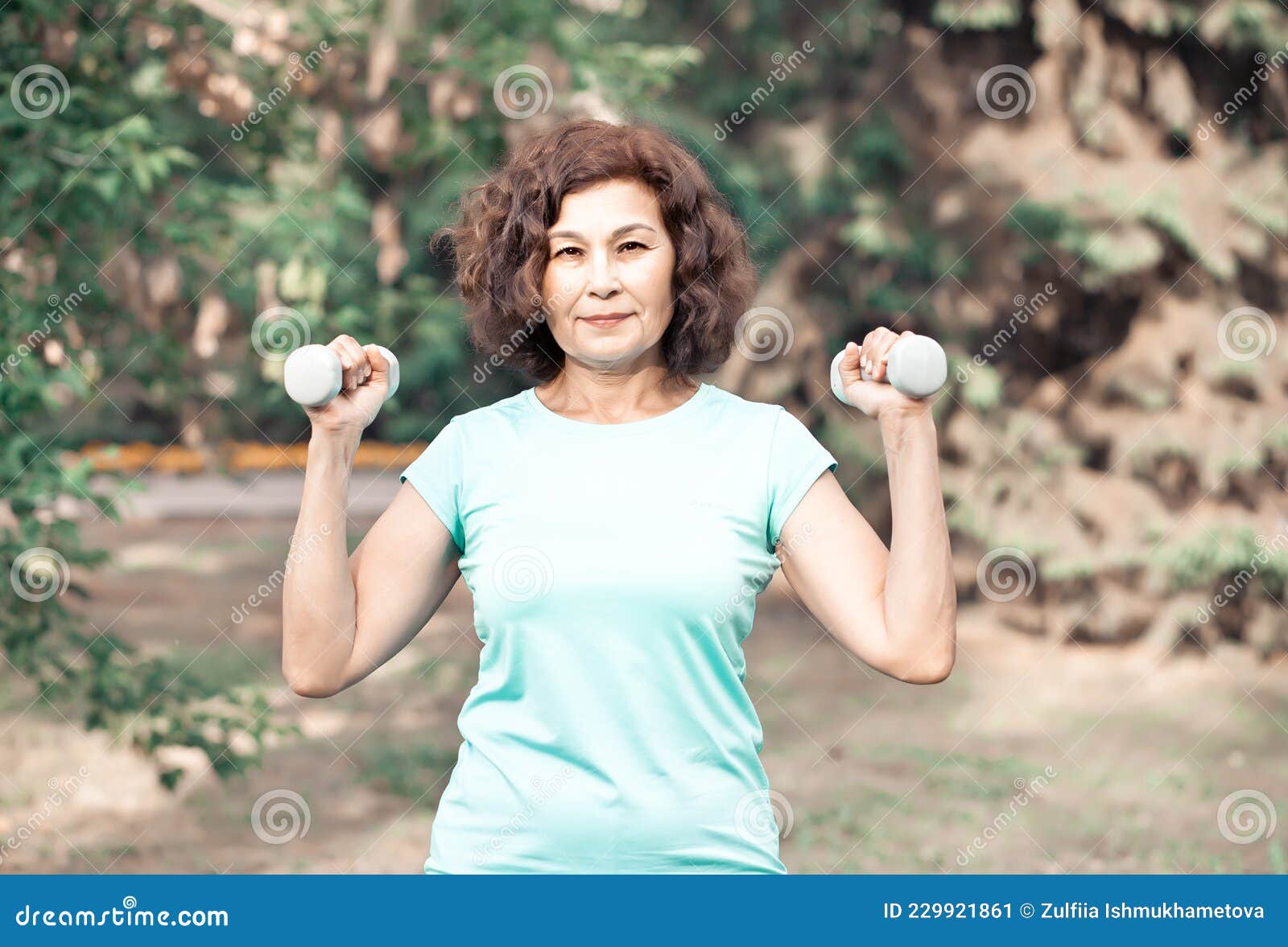 Middle Aged Elderly Active Woman Doing Exercise in a Park Outdoor Stock ...
