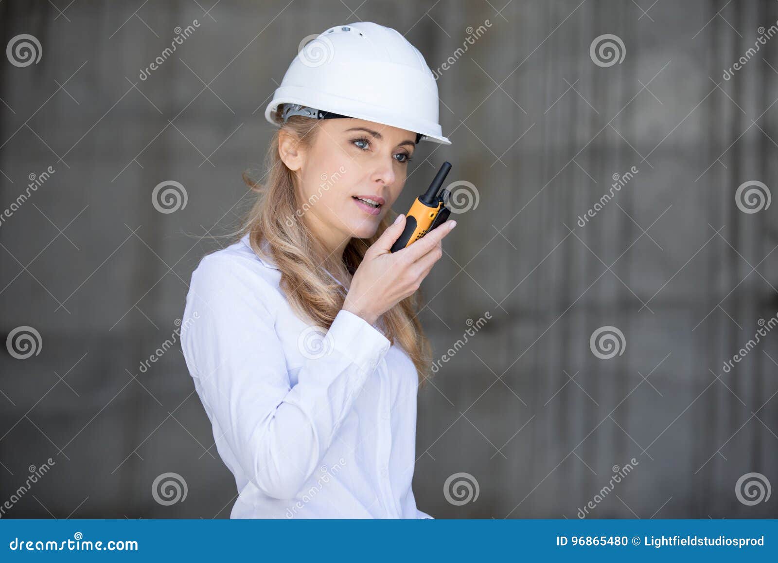 Middle Aged Engineer in Hard Hat Using Walkie-talkie while Working ...