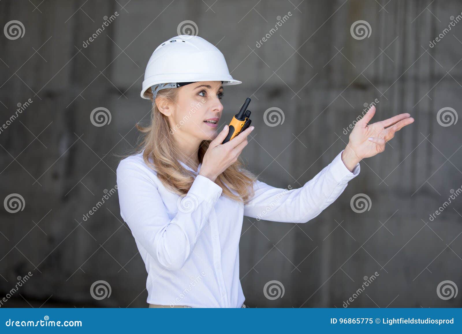 Middle Aged Engineer in Hard Hat Using Walkie-talkie while Working ...