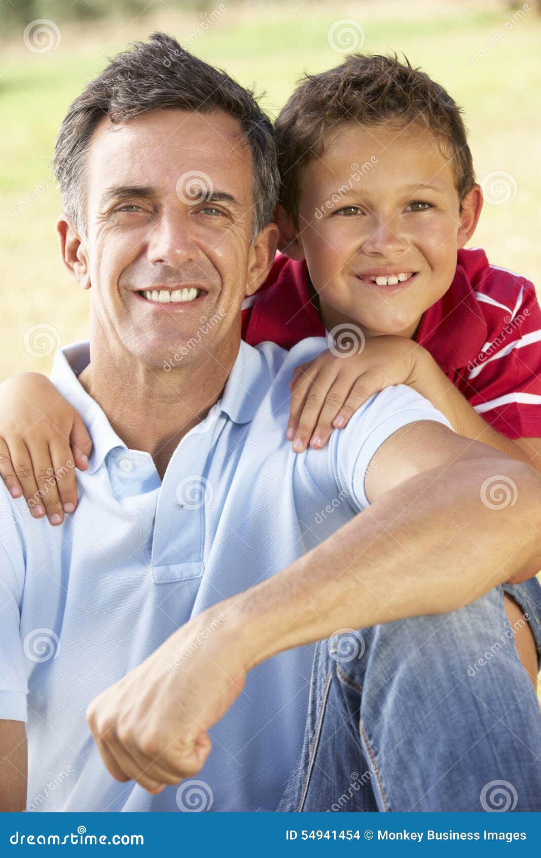 Middle Aged Father and Son Relaxing in Countryside Stock Photo - Image ...