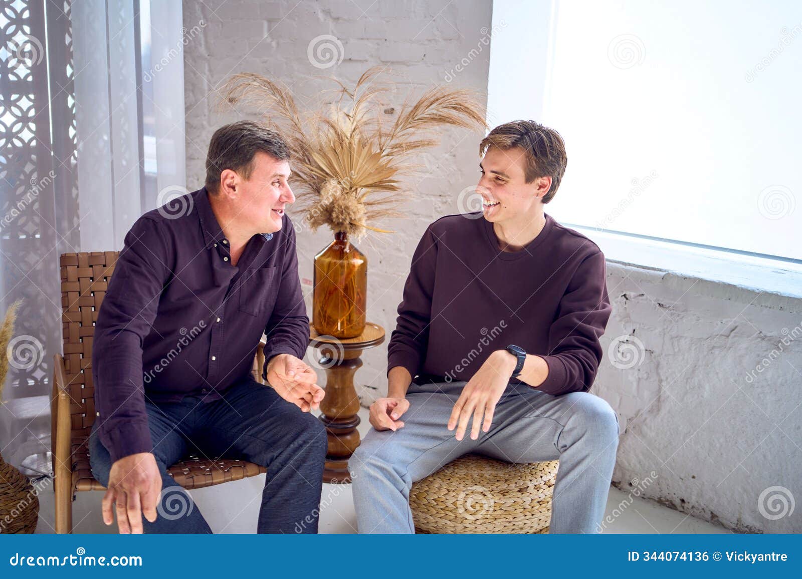 Middle-aged Father Talking and Laughing with His Young Son Stock Photo ...