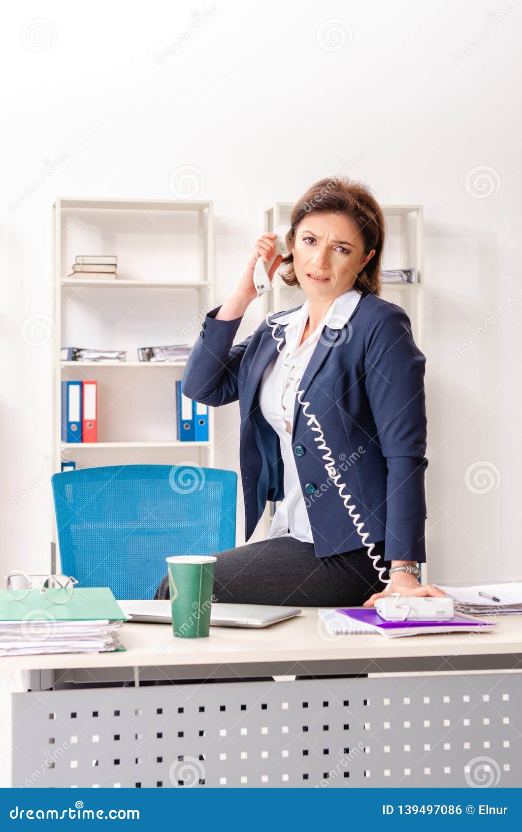The Middle-aged Female Employee Sitting at the Office Stock Photo ...