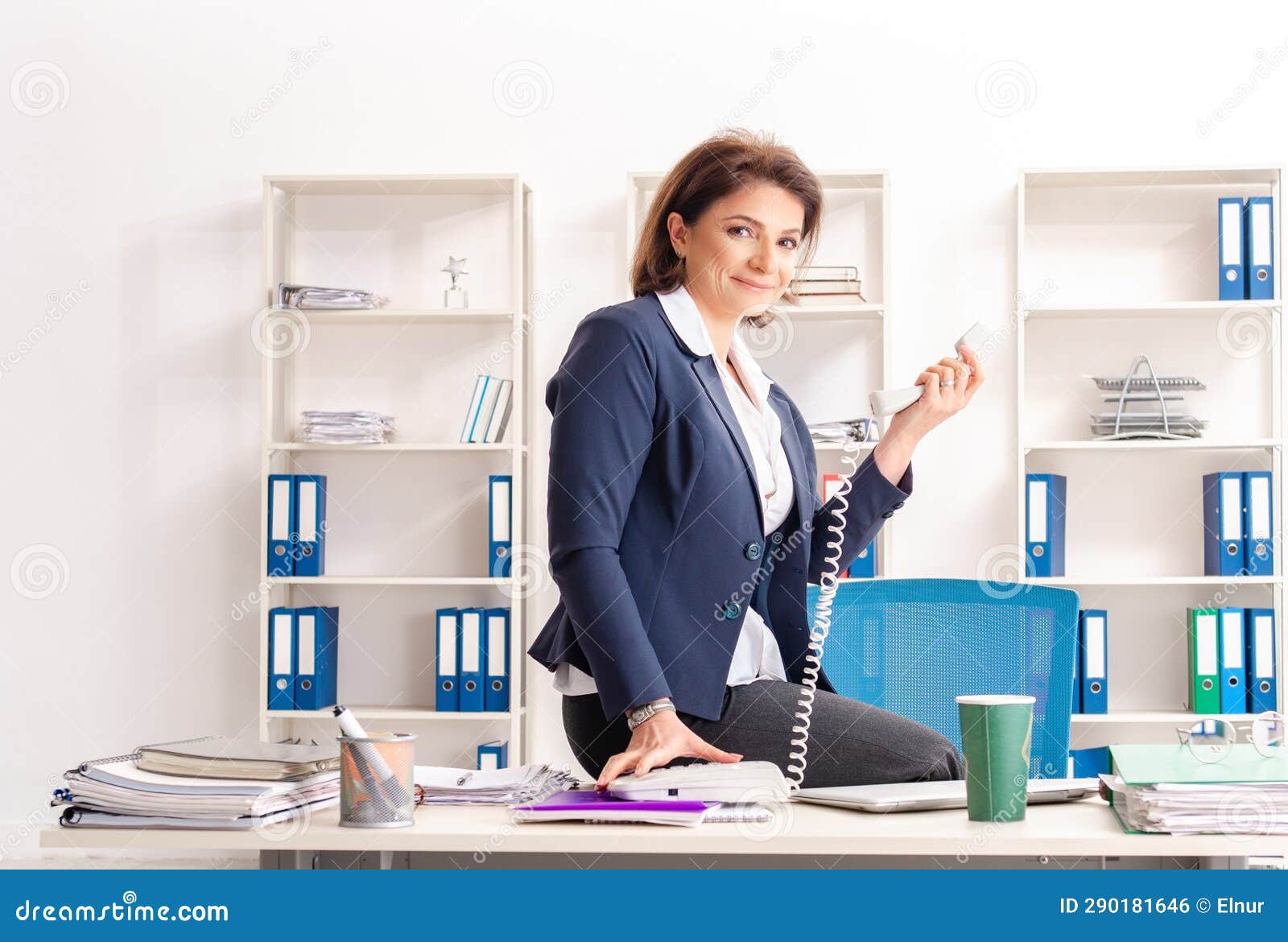 Middle-aged Female Employee Sitting at the Office Stock Photo - Image ...