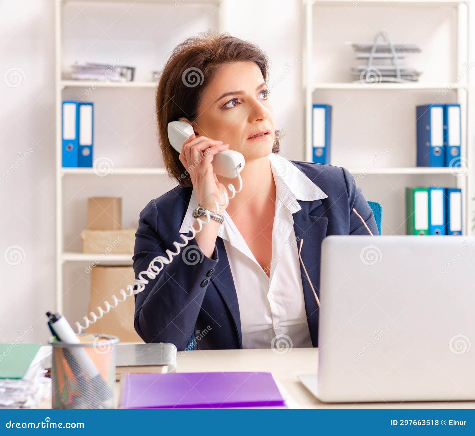 Middle-aged Female Employee Sitting at the Office Stock Photo - Image ...