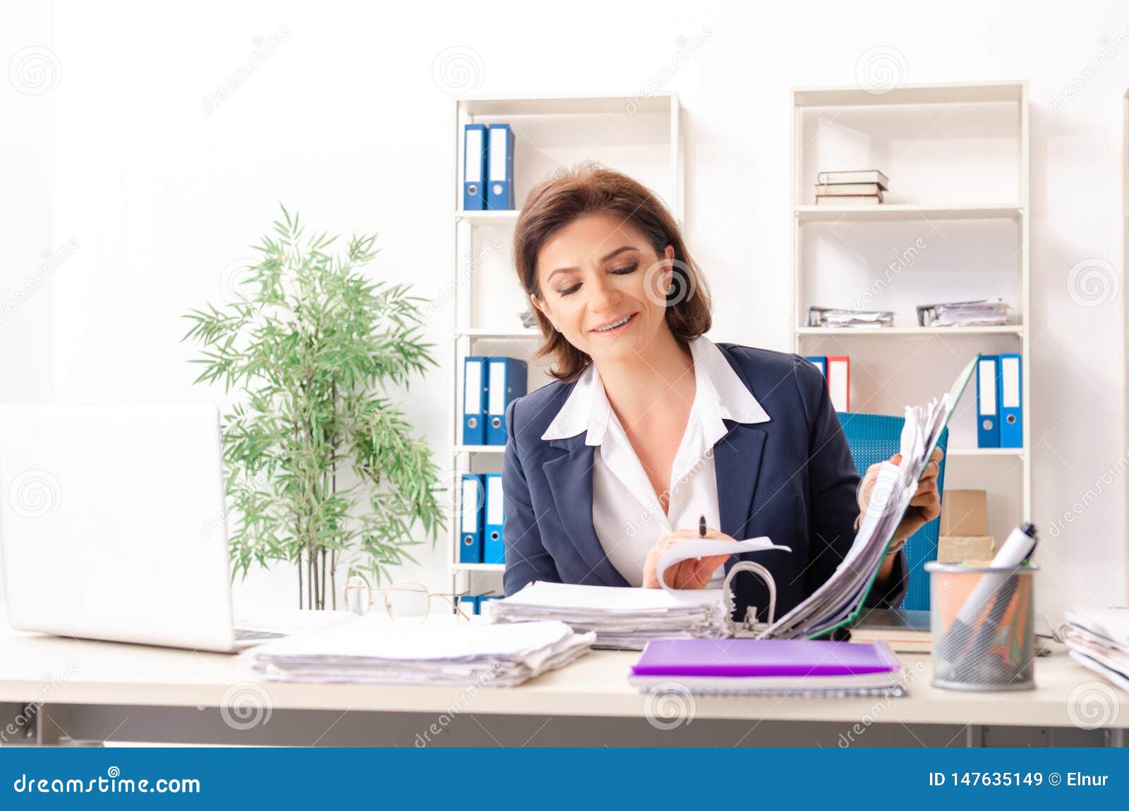 The Middle-aged Female Employee Sitting at the Office Stock Image ... The Middle-aged Female Employee Sitting at the Office Stock Image ...