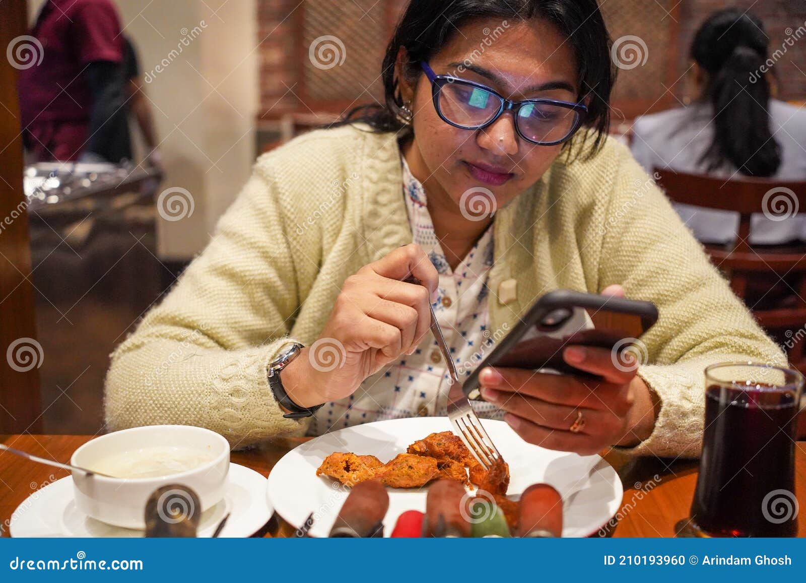 A Middle Aged Indian Lady in Spectacles Having Dinner Holding a Fork ...