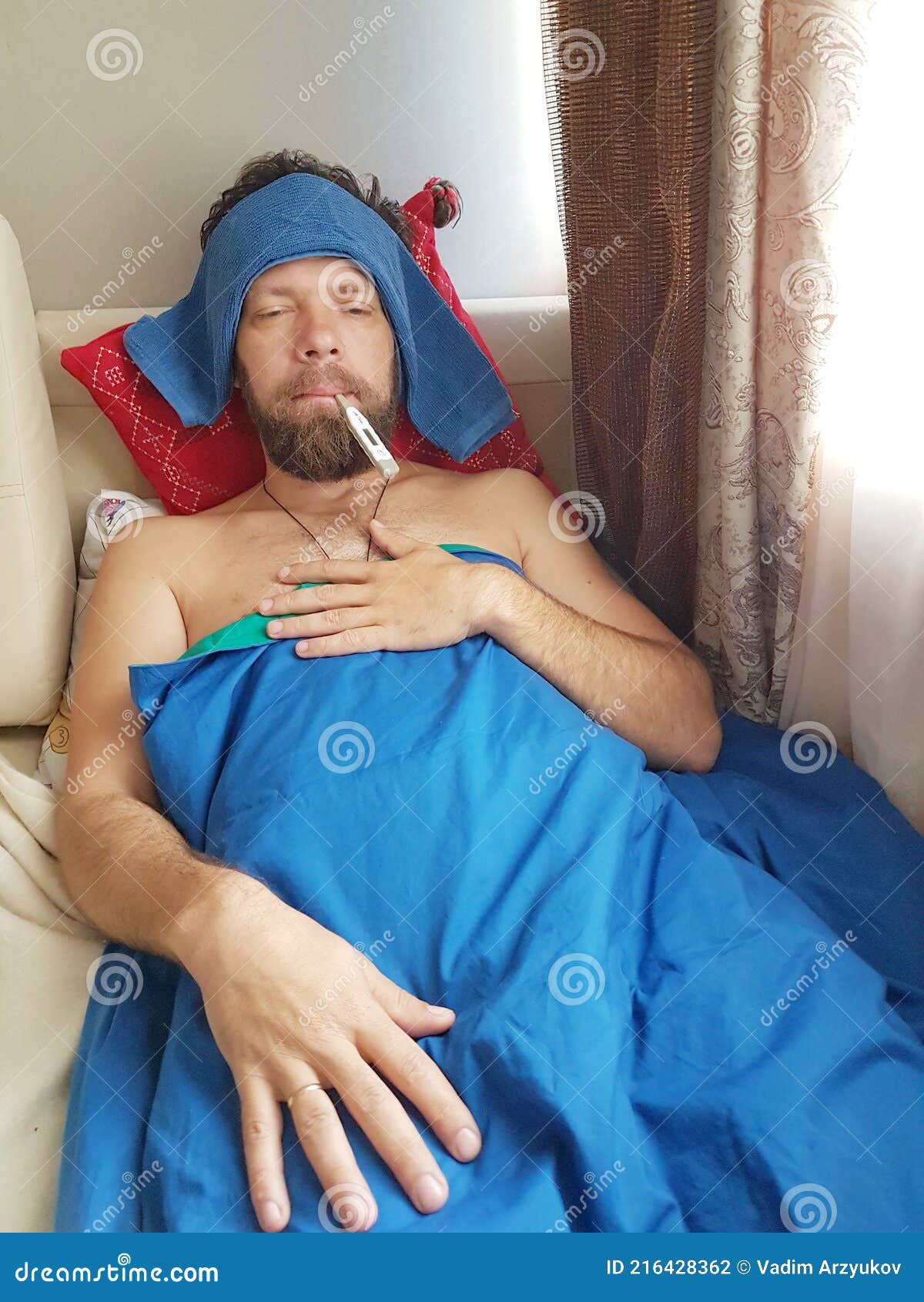 A Middle-aged Man with a Beard is Sick with a Thermometer. Stock Photo ...