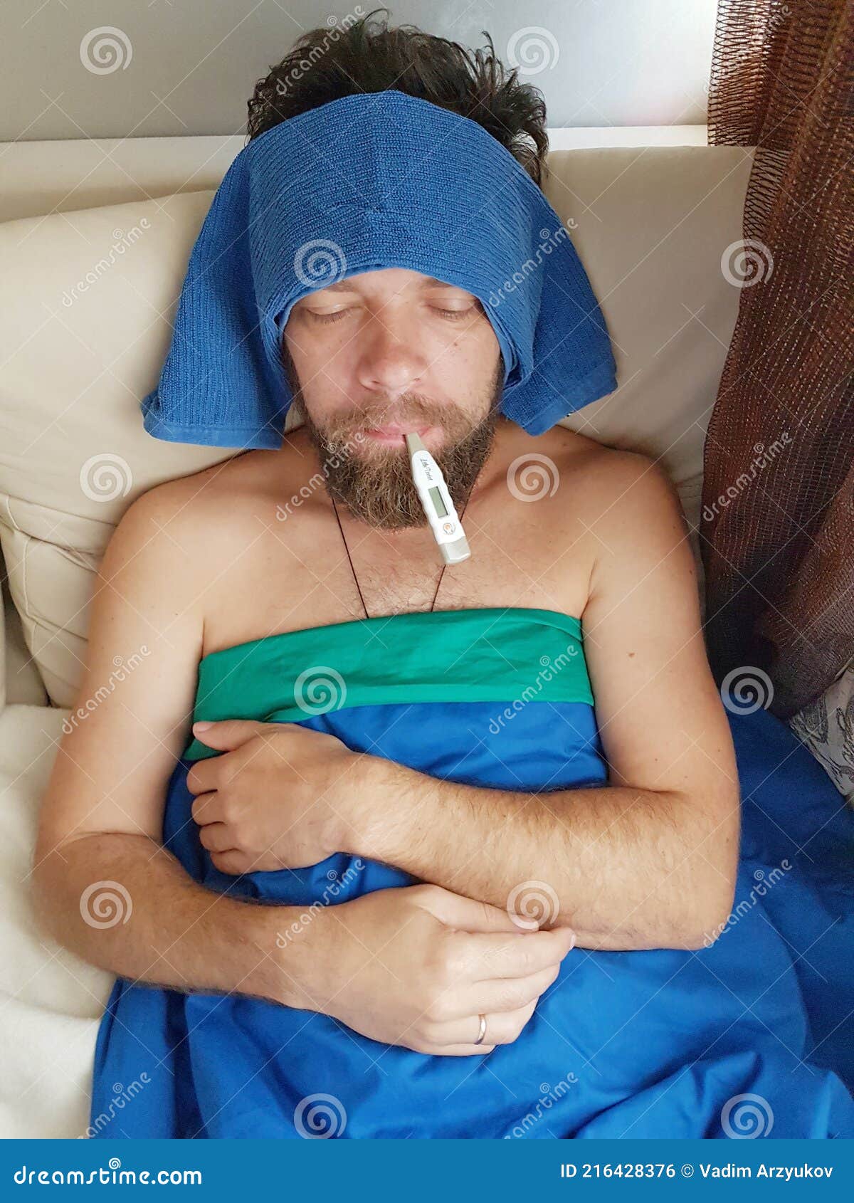 A Middle-aged Man with a Beard is Sick with a Thermometer. Stock Photo ...