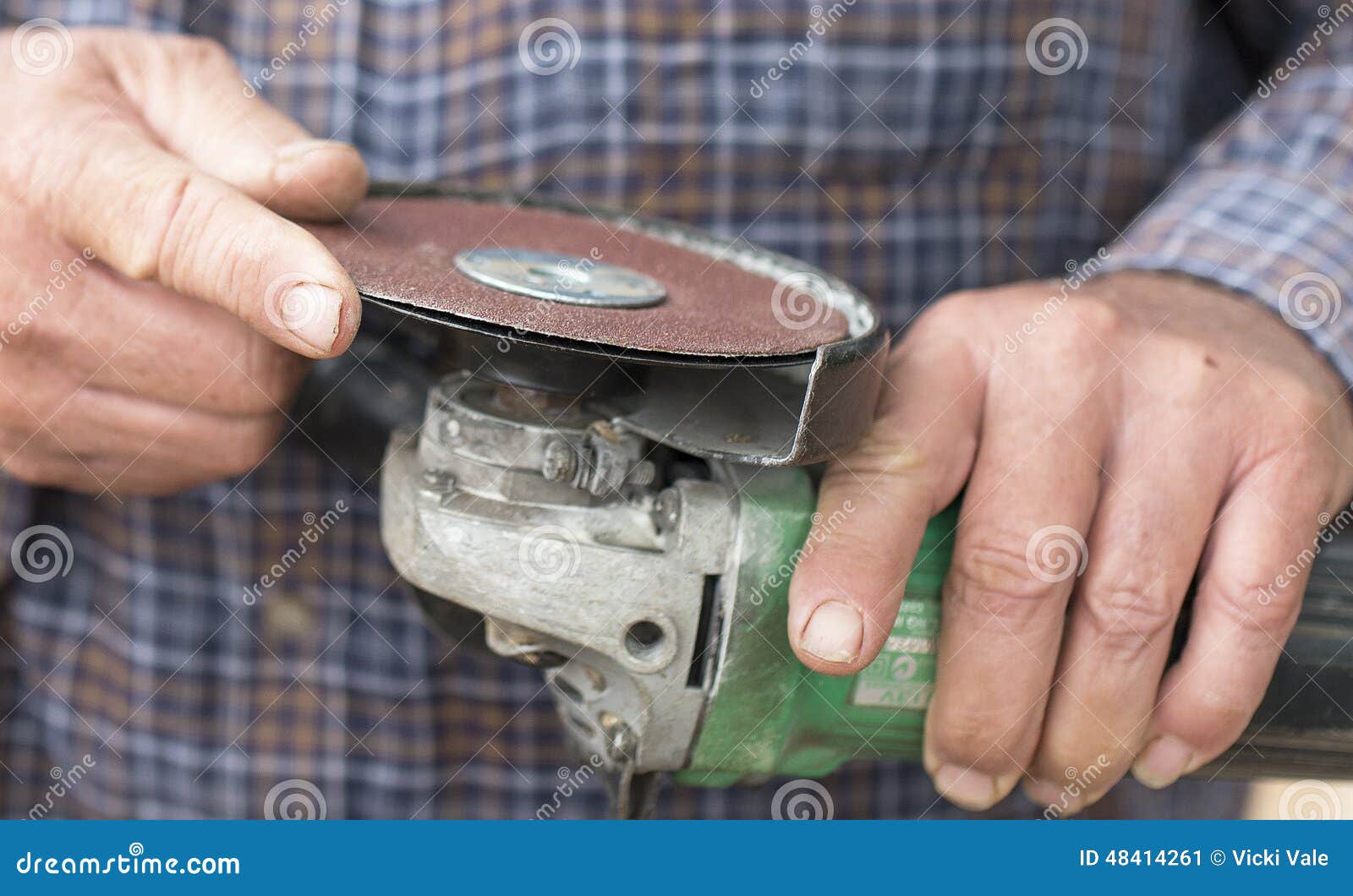 Middle-aged Man Checking Angle Grinder. Stock Image - Image of checking ...