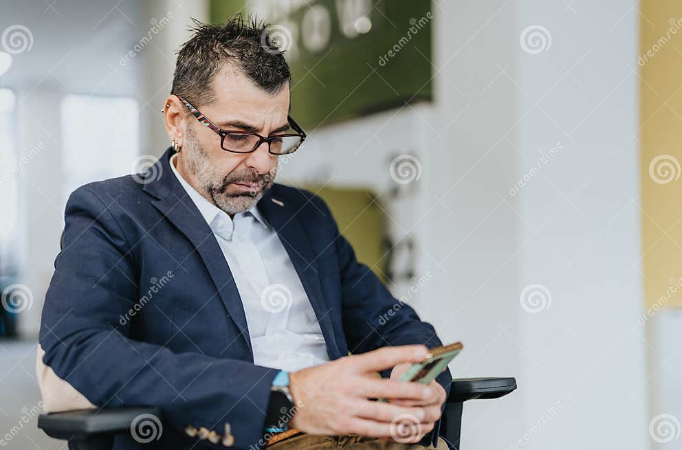 Middle-aged Man Checking Phone during Break at Work. Stock Photo ...
