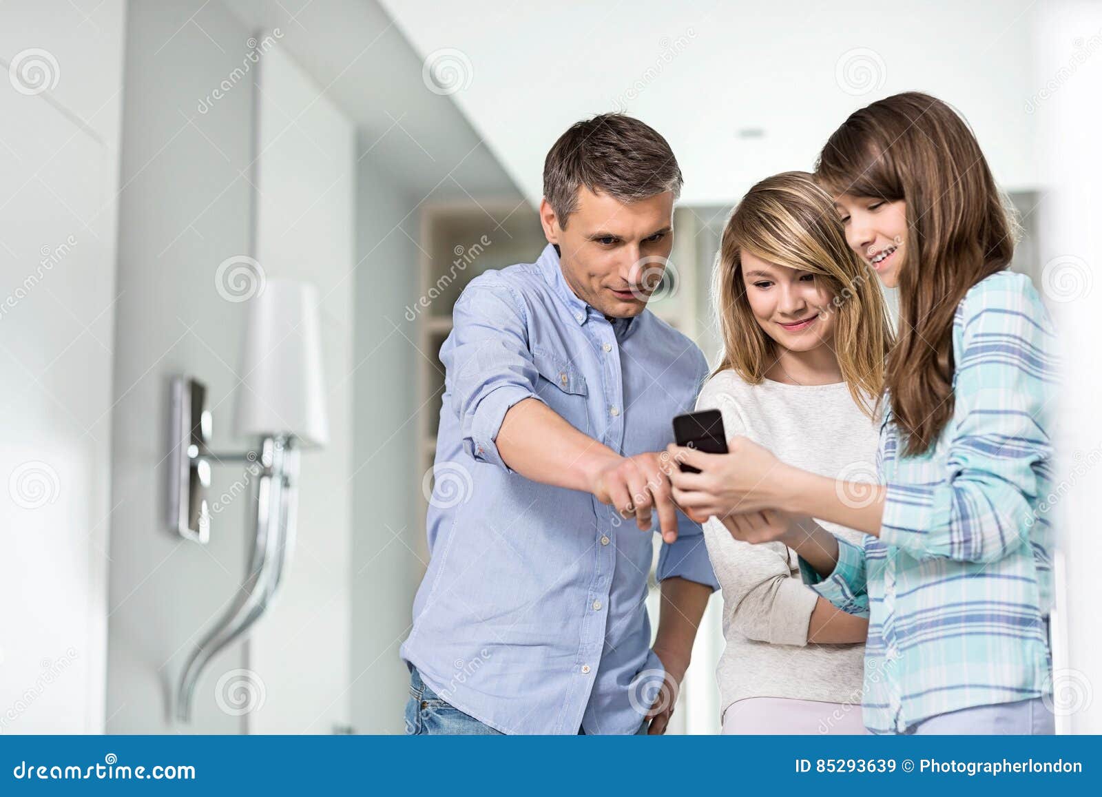Middle-aged Man with Daughters Using Smart Phone at Home Stock Image ...