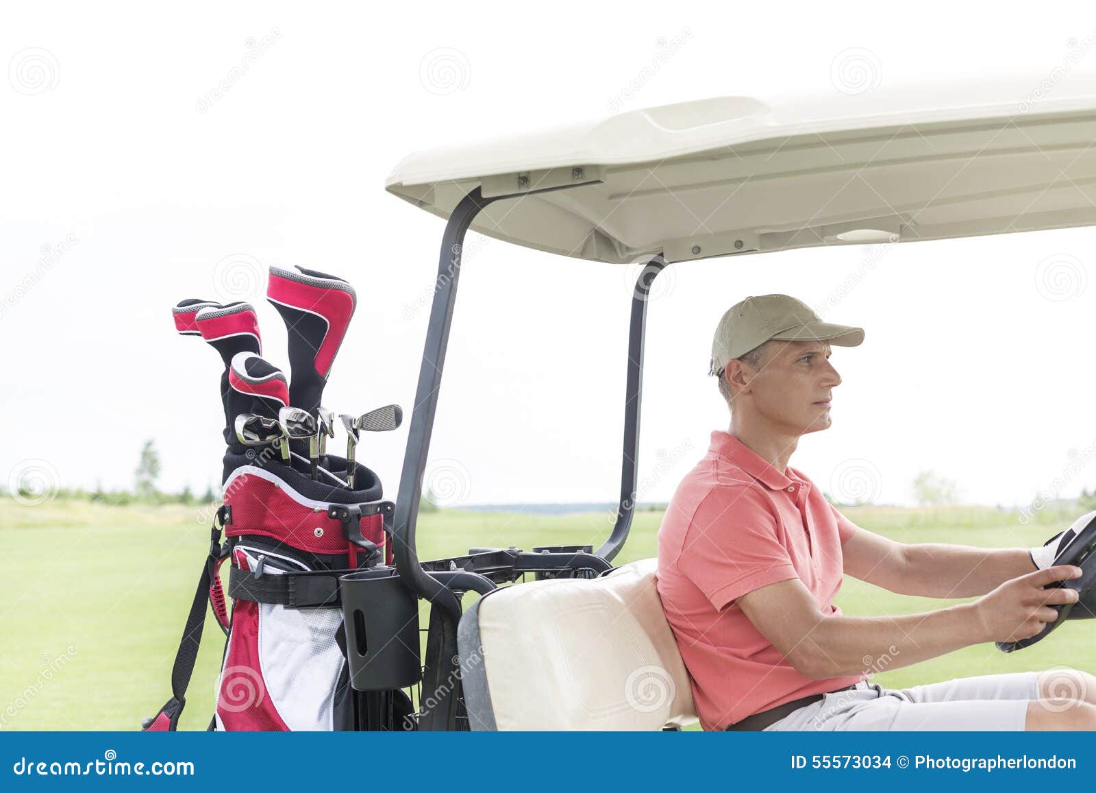 Middle-aged Man Driving Golf Cart at Course Stock Photo - Image of ...