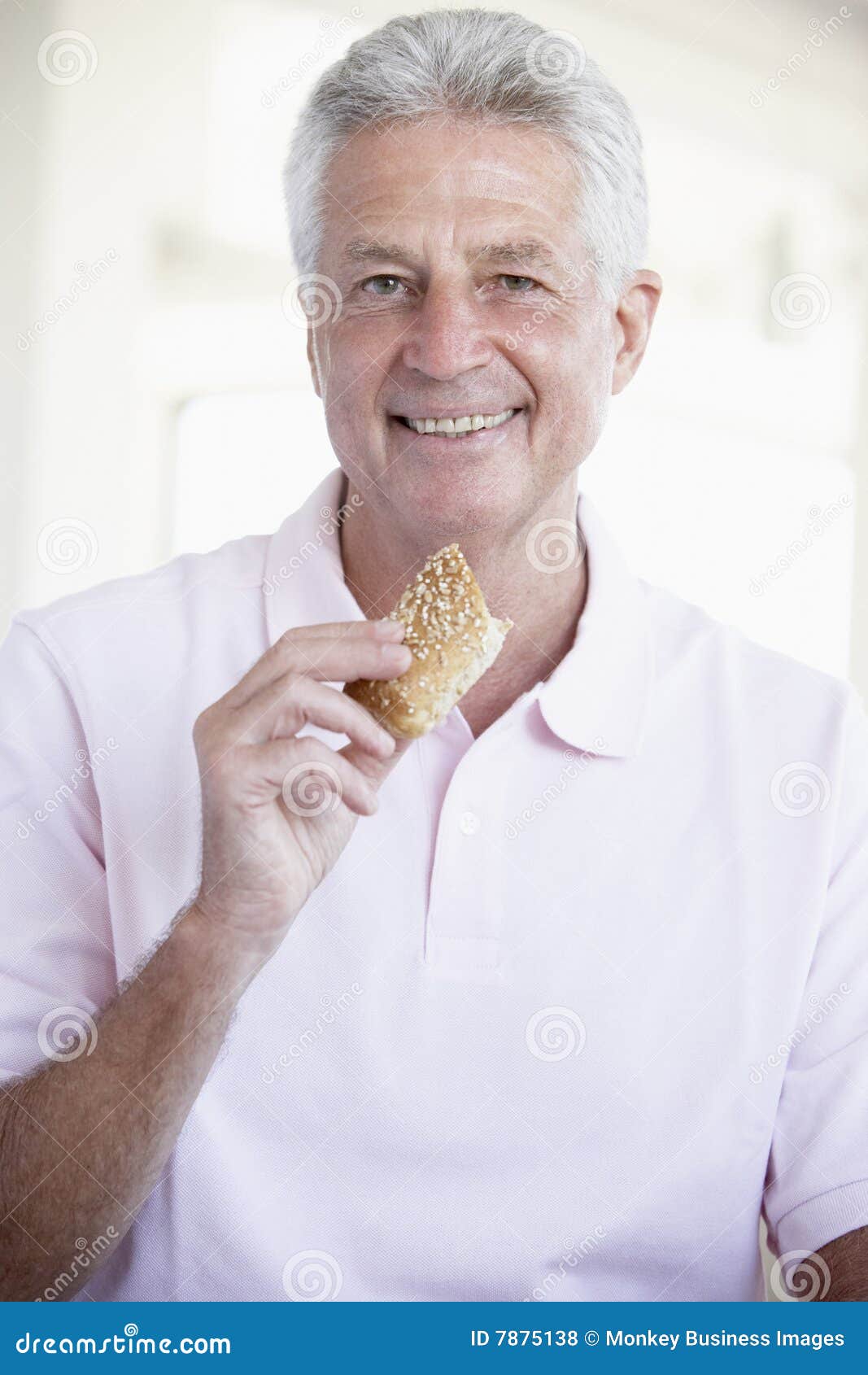 Middle Aged Man Eating Brown Bread Roll Stock Photo - Image of colour ...