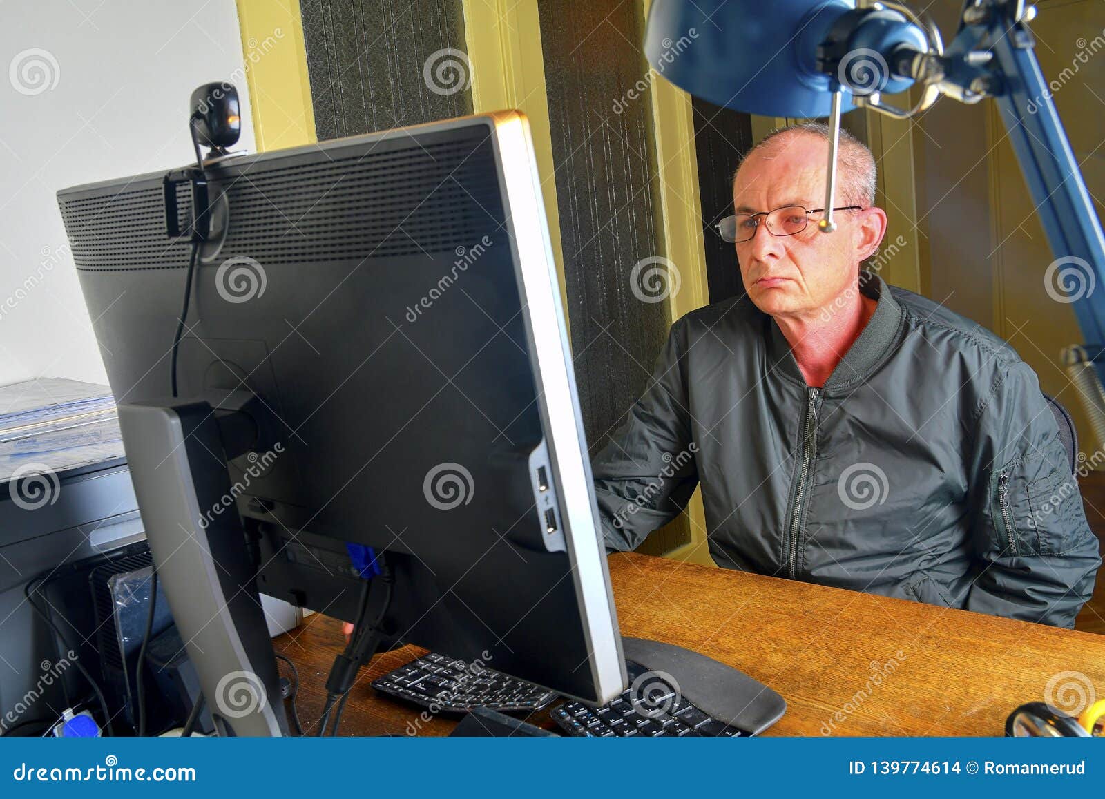 Middle Aged Man with Glasses Sitting at Desk. Mature Man Using Personal ...