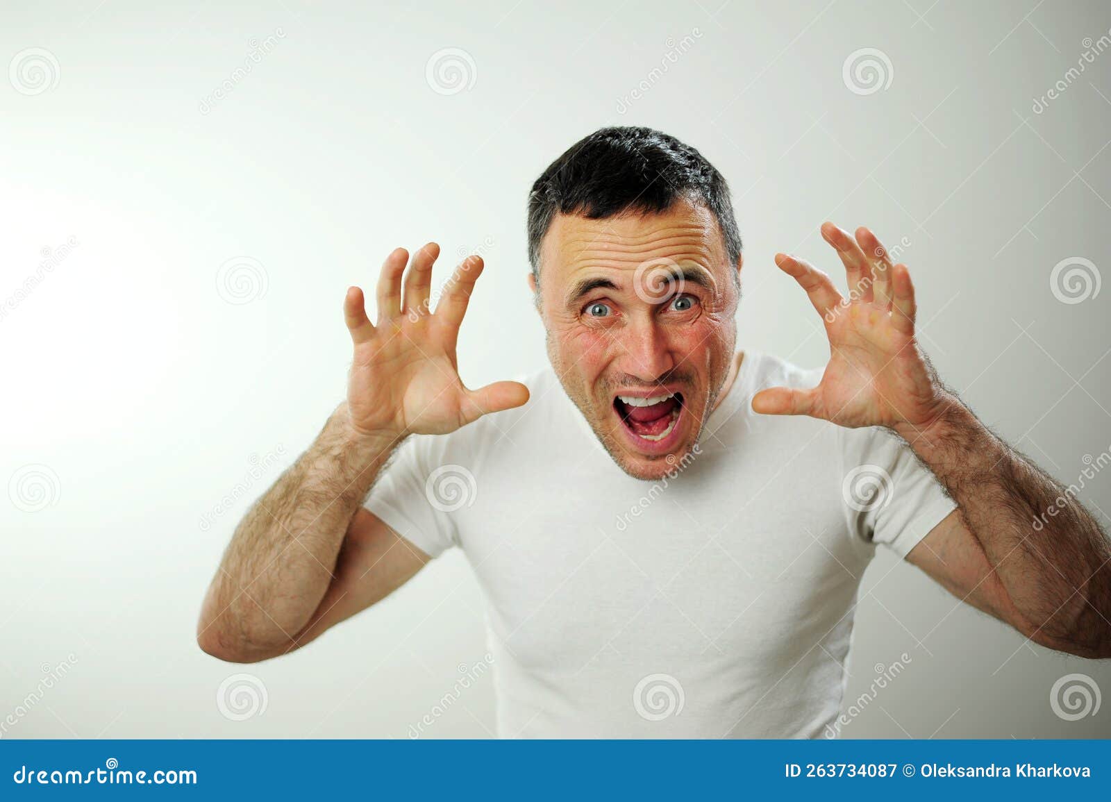A Middle-aged Man with Kind Eyes As If Trying To Scare Someone, Spread ... A Middle-aged Man with Kind Eyes As If Trying To Scare Someone, Spread ...