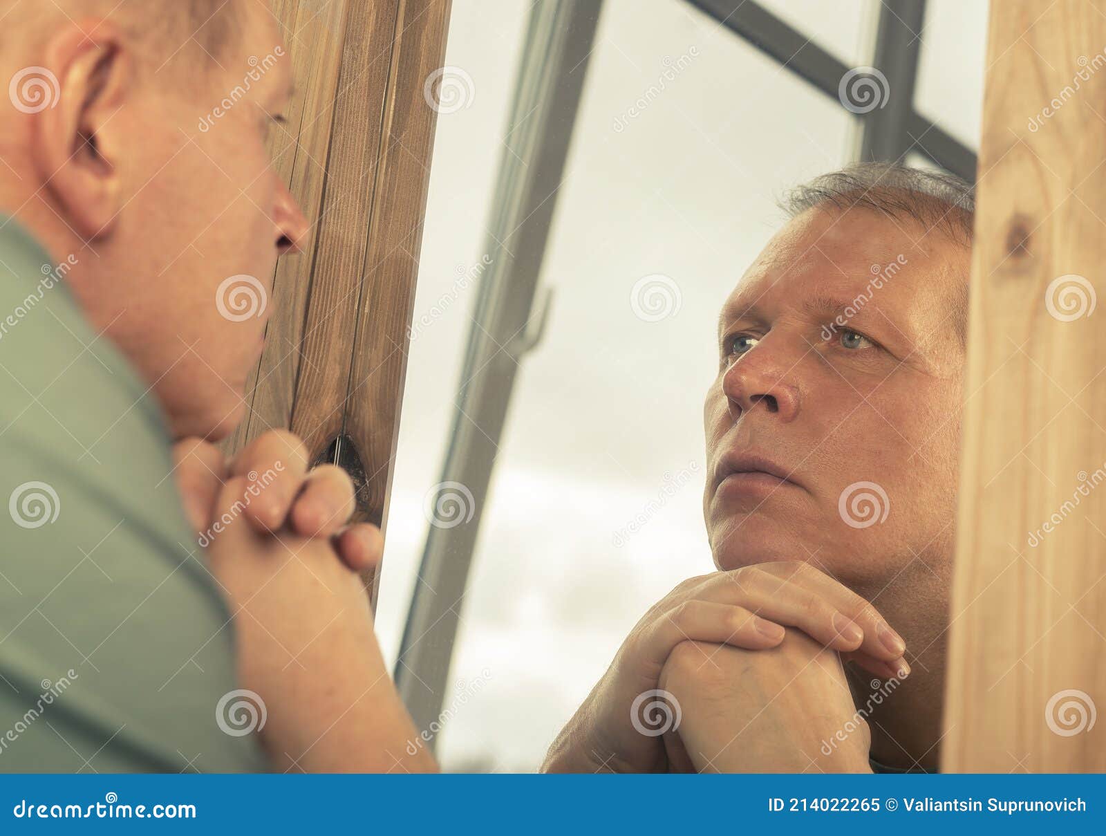 Middle-aged Man Looking at Mirror Reflection Seriously, Thinking about ...
