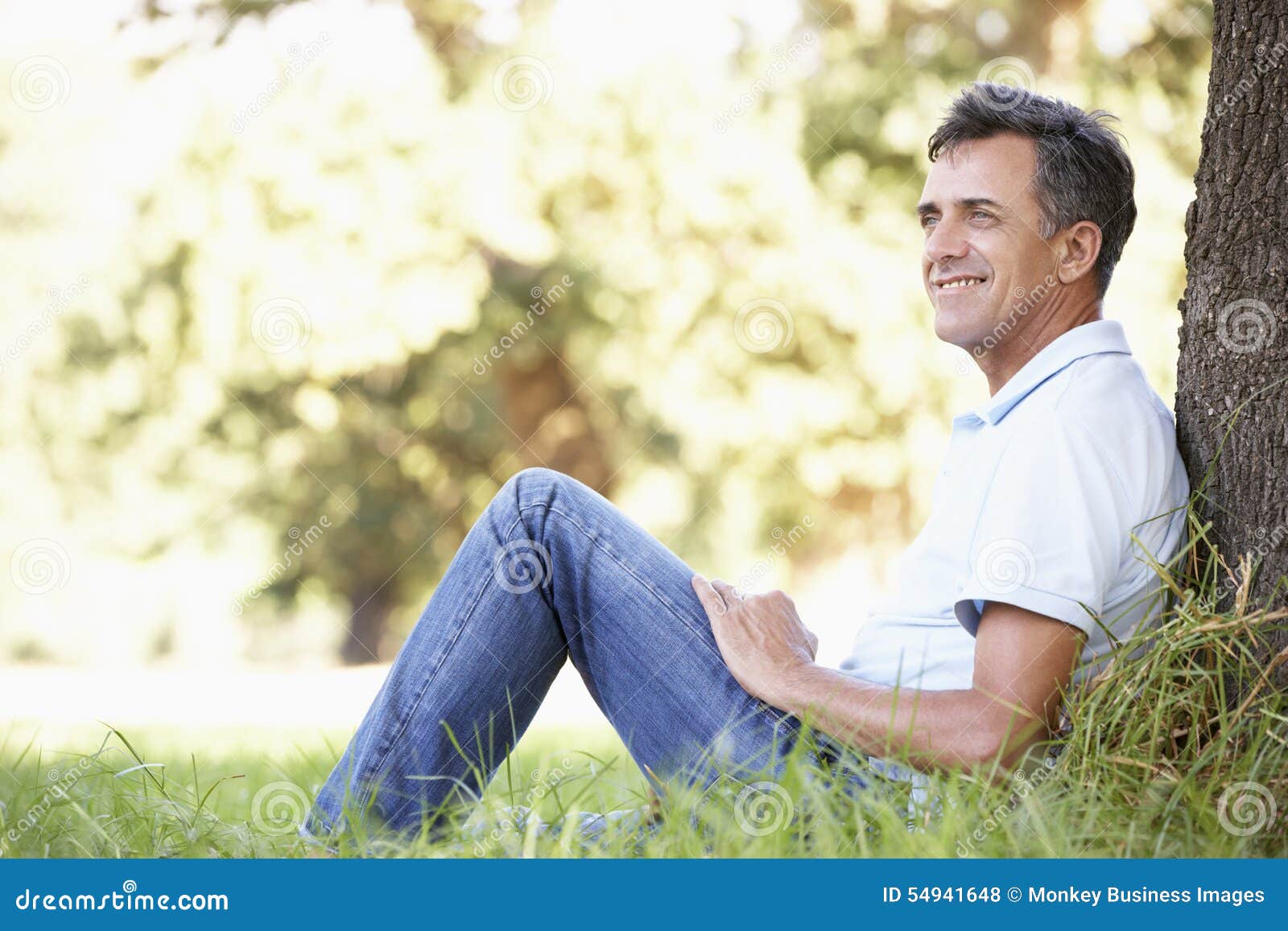 Middle Aged Man Relaxing in Countryside Leaning Against Tree Stock ...