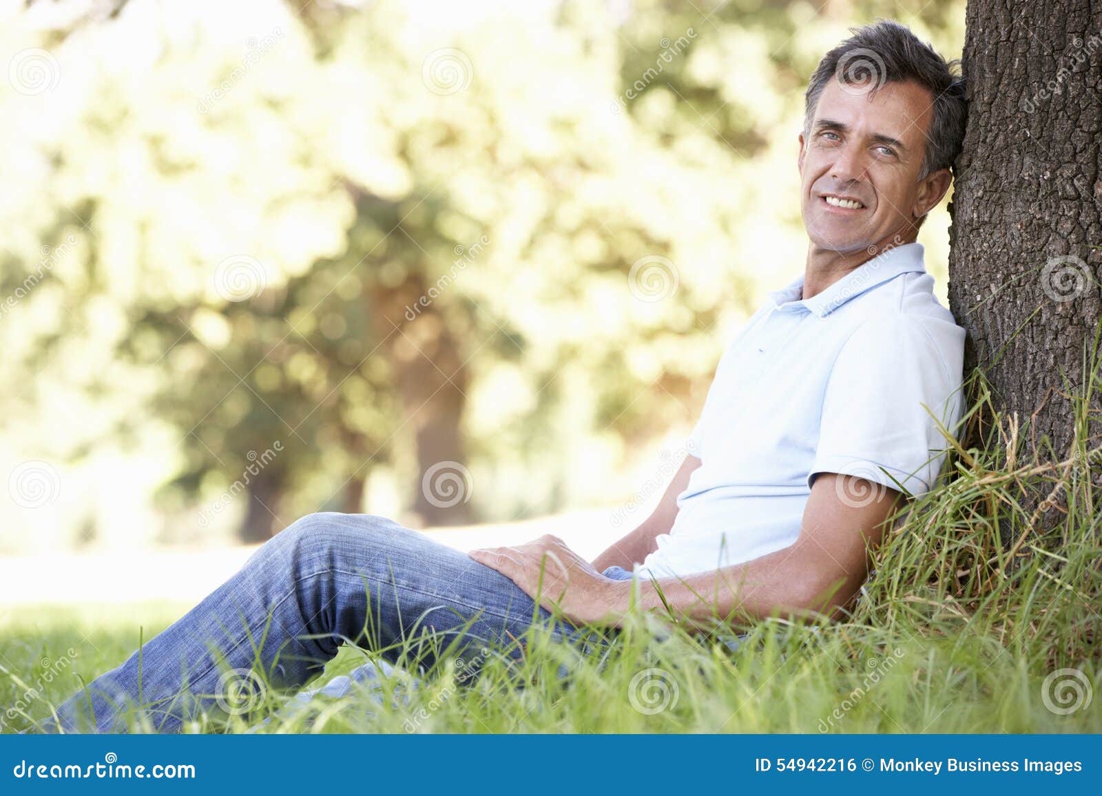 Middle Aged Man Relaxing in Countryside Leaning Against Tree Stock ...
