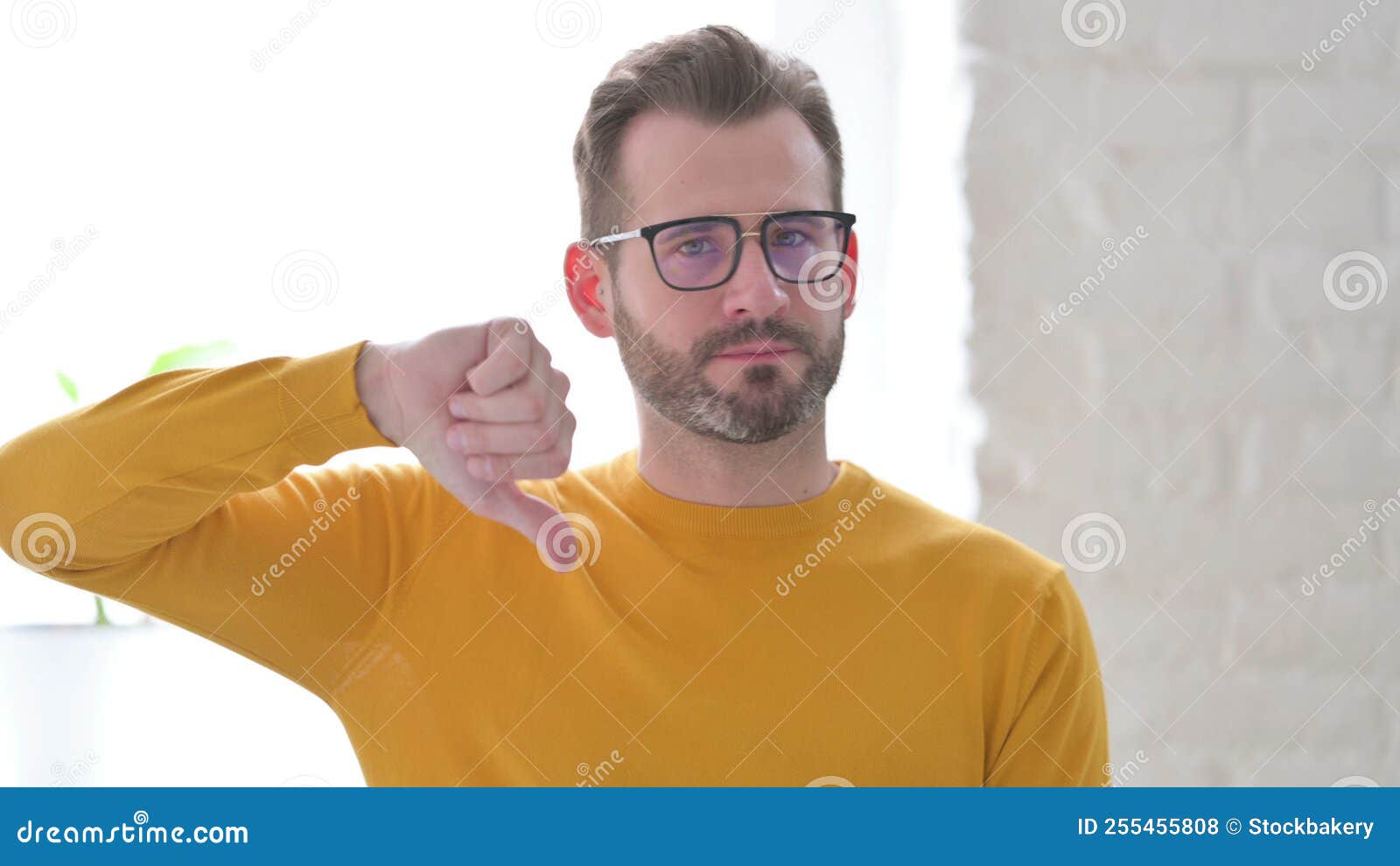 Portrait of Man Showing Thumbs Down Gesture Stock Photo - Image of ...