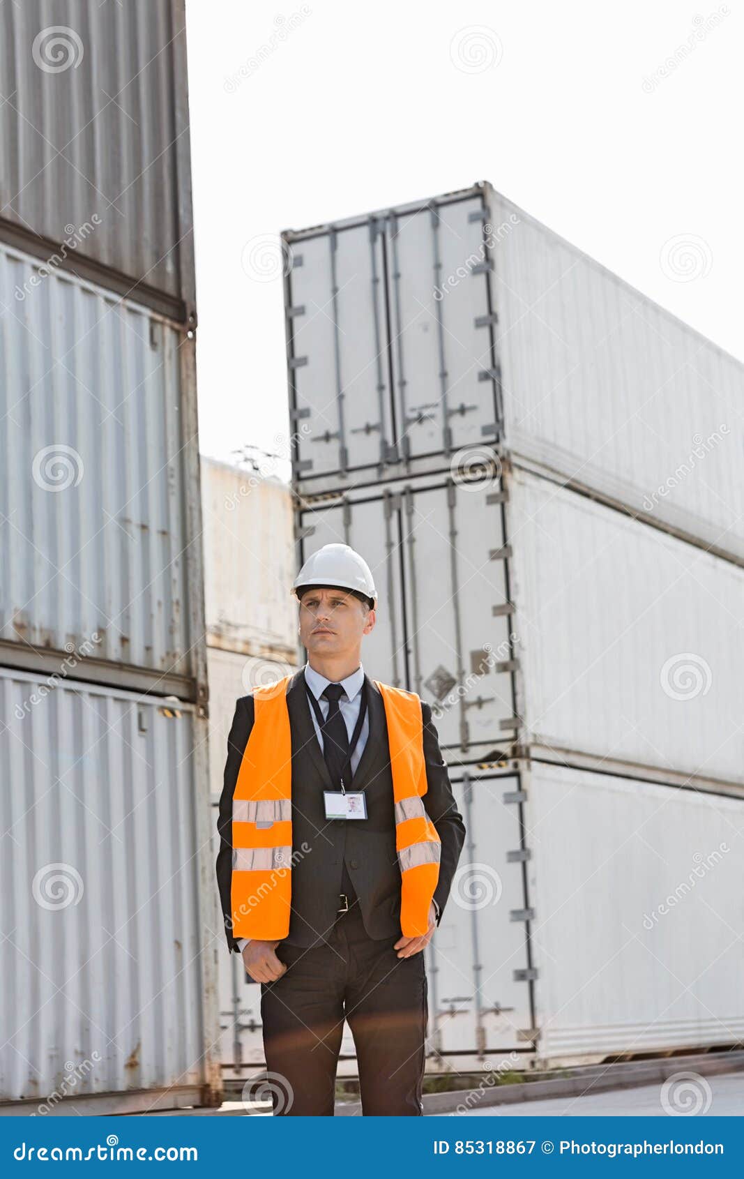 Middle-aged Man Standing Against Cargo Containers in Shipping Yard ...