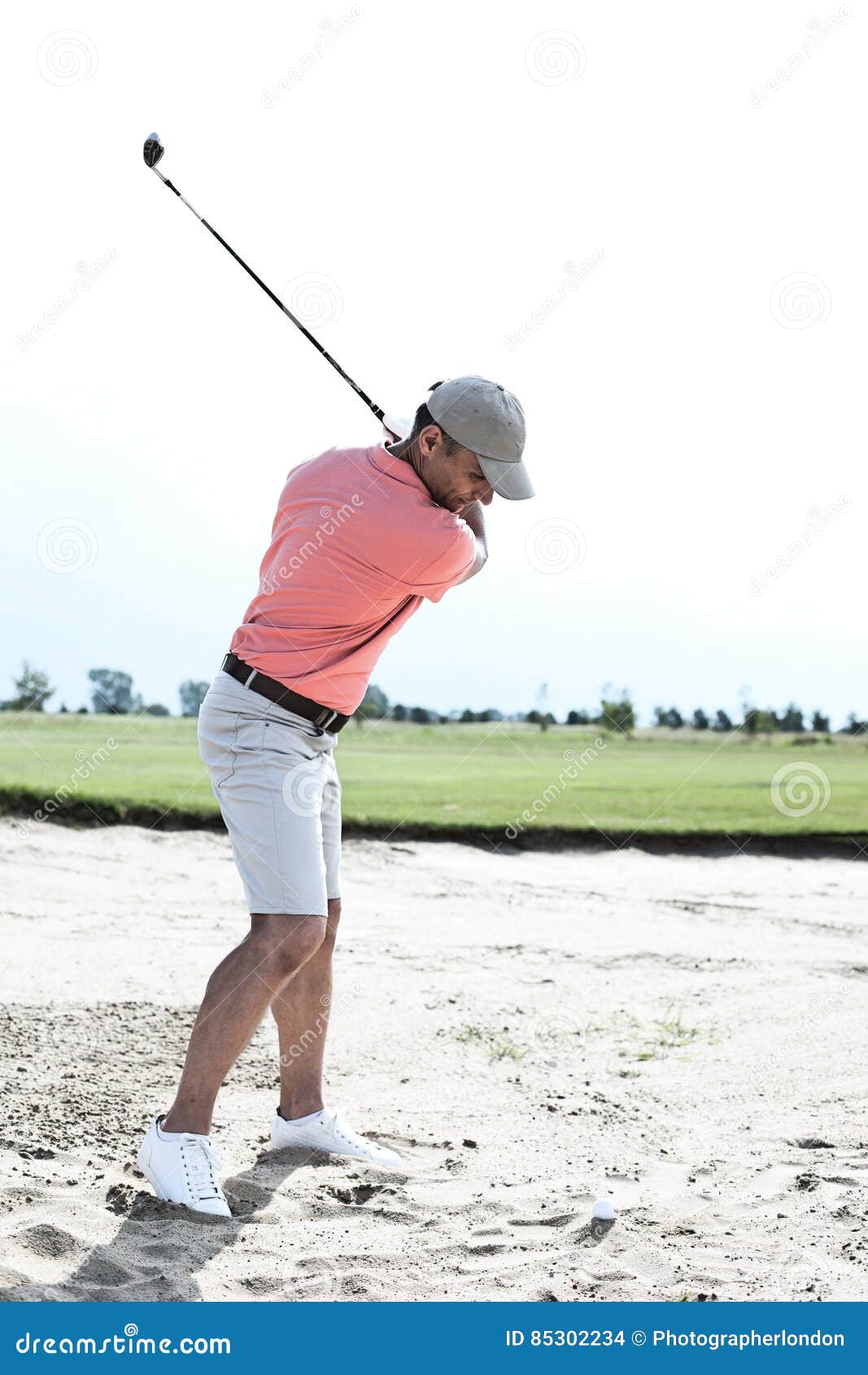 Middle-aged Man Swinging at Golf Course Against Clear Sky Stock Photo ...