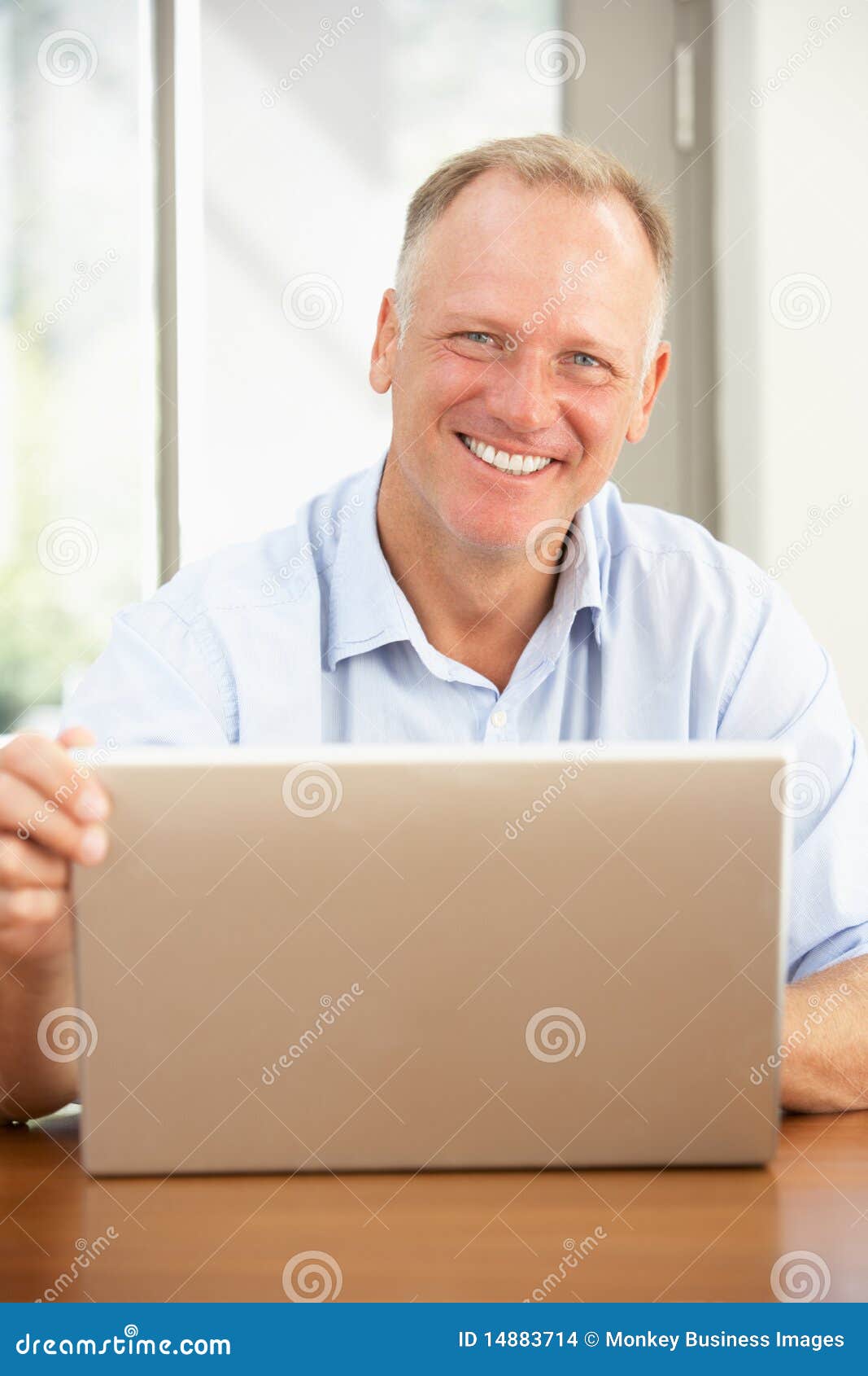 Middle Aged Man Using Laptop at Home Stock Photo - Image of smiling ...