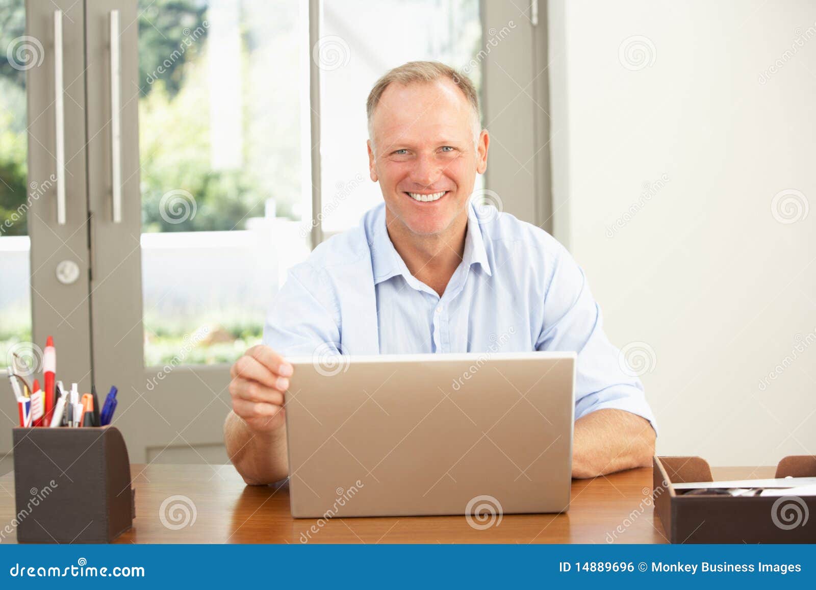 Middle Aged Man Using Laptop at Home Stock Photo - Image of living ...